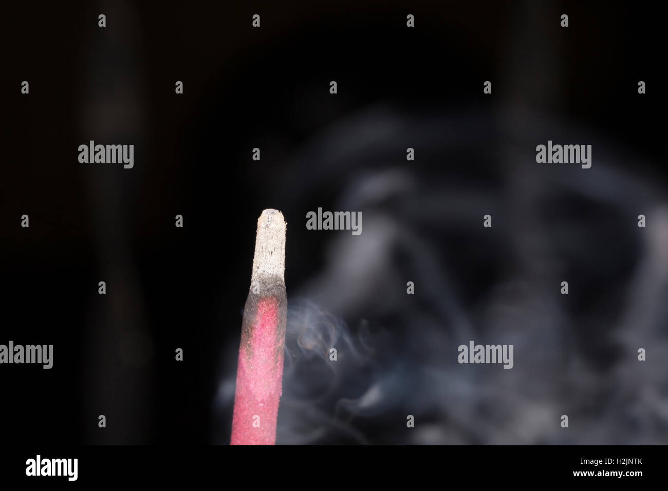 Tip of burning incense stick Stock Photo - Alamy