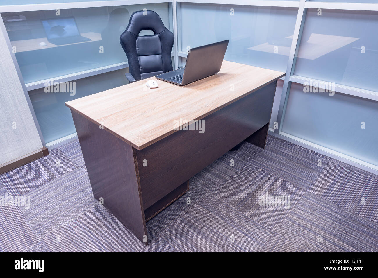 Office desk with note book and chair in the corner of the office Stock ...