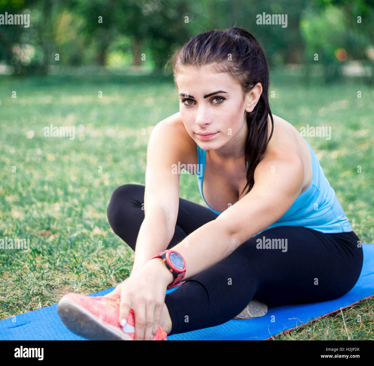 Young fitness girl stretches for training workout outdoor Stock Photo ...