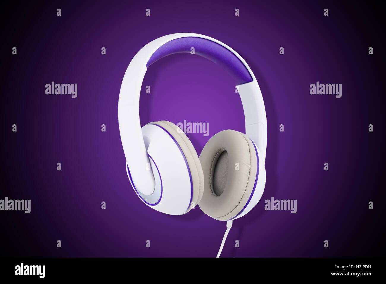 White and purple padded headphones isolated on purple background Stock ...