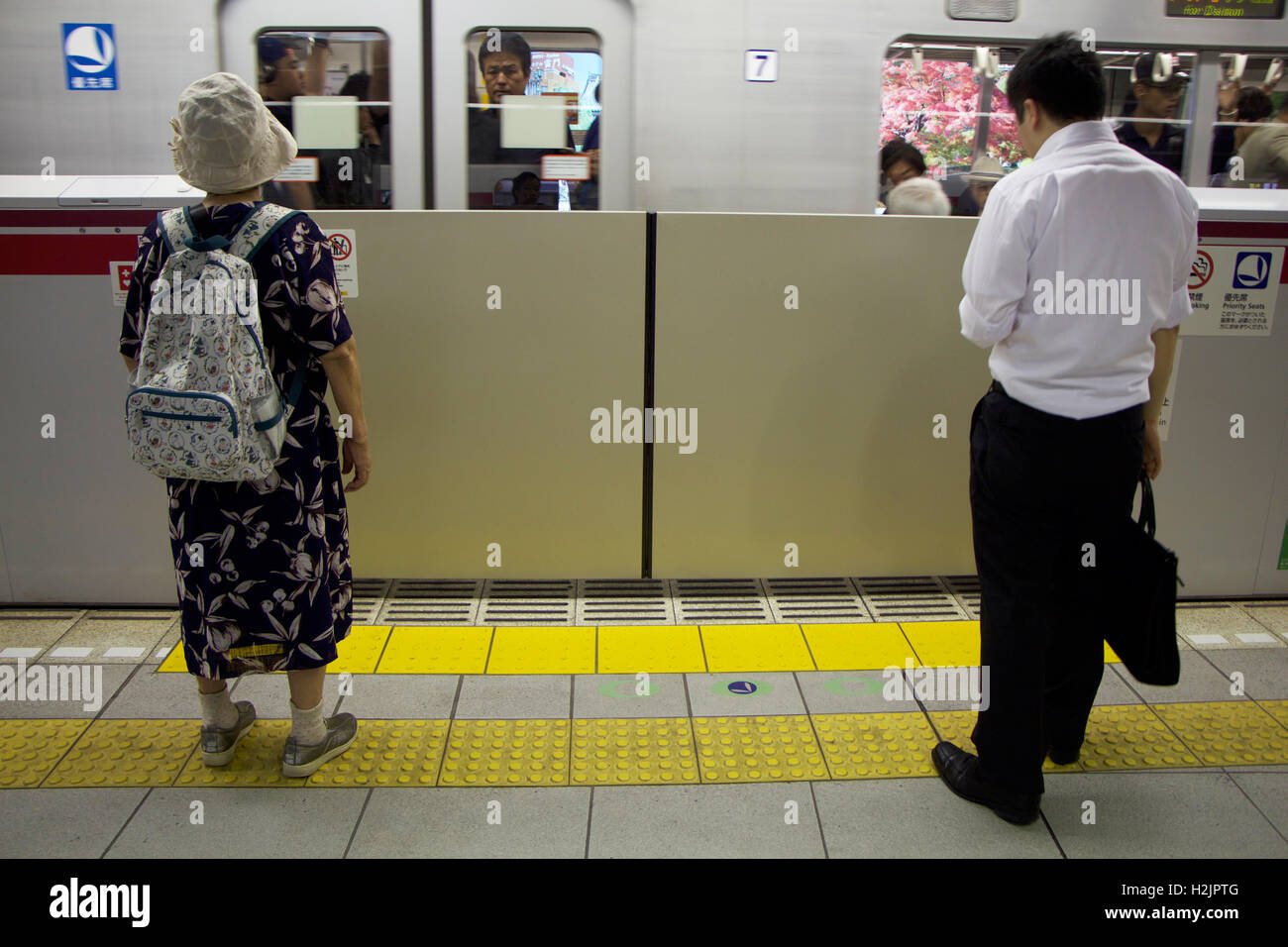 Waiting in line to board the rail Stock Photo - Alamy
