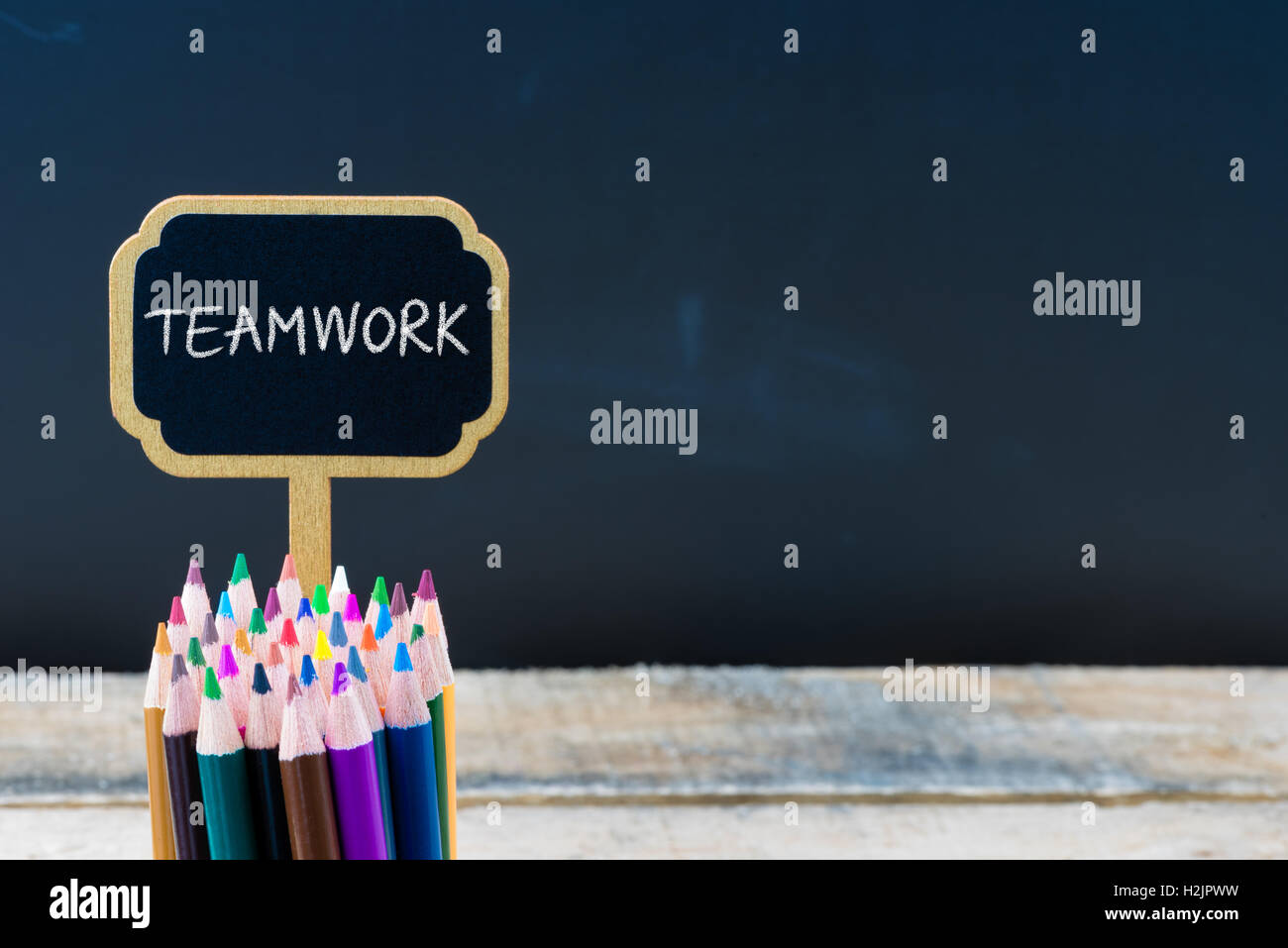 Wooden mini blackboard label with message TEAMWORK and colouring ...