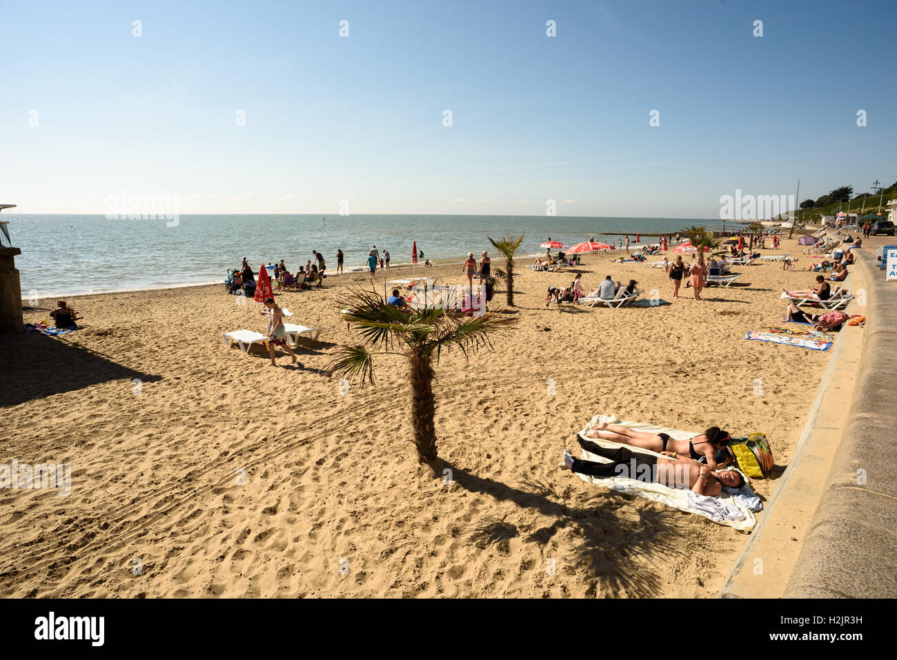 Group of people enjoying the summer sun at the beach near Clacton Pier ...