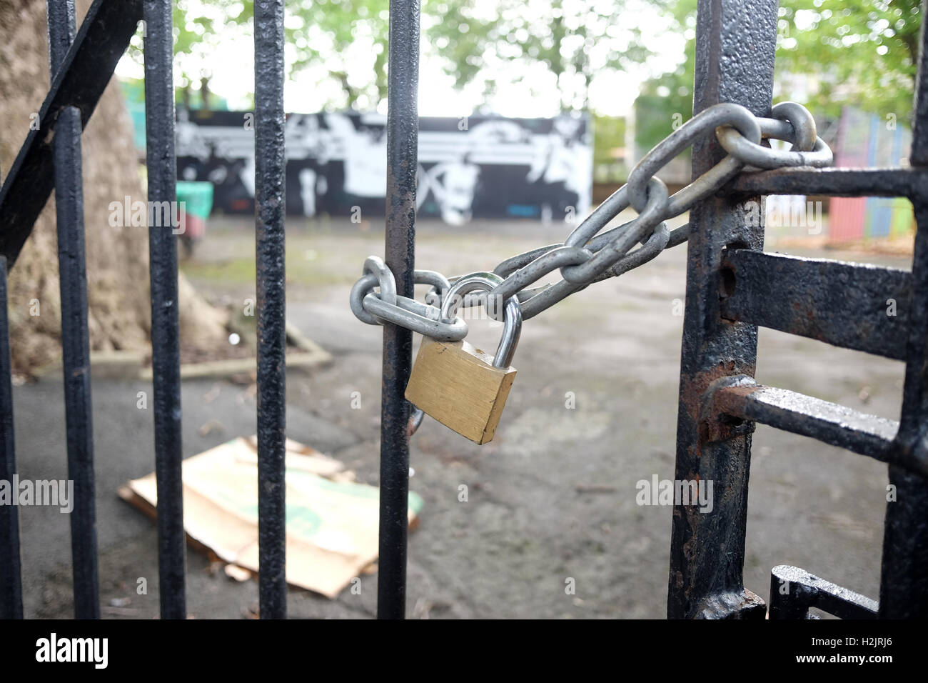 Securely gated children's playground, with a sports montage in the back ...