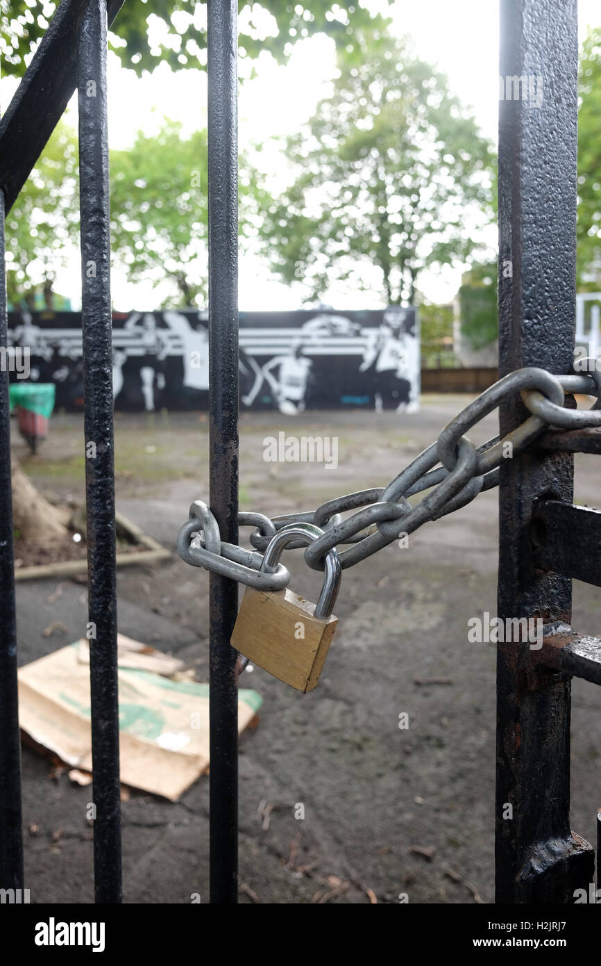 Securely gated children's playground, with a sports montage in the back ...
