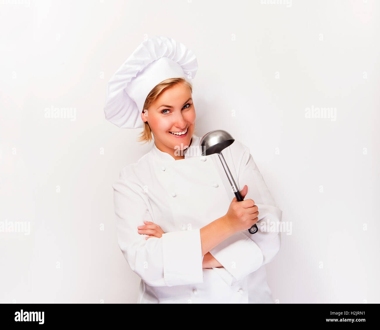 Young woman chef holding ladle, smiling Stock Photo - Alamy