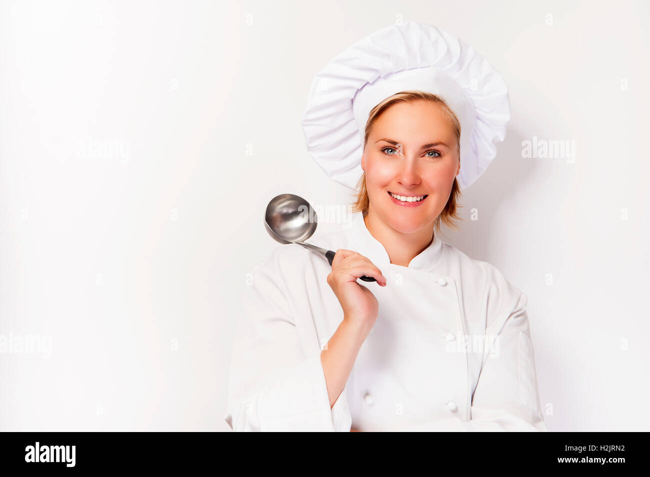 Young woman chef holding ladle, smiling Stock Photo - Alamy