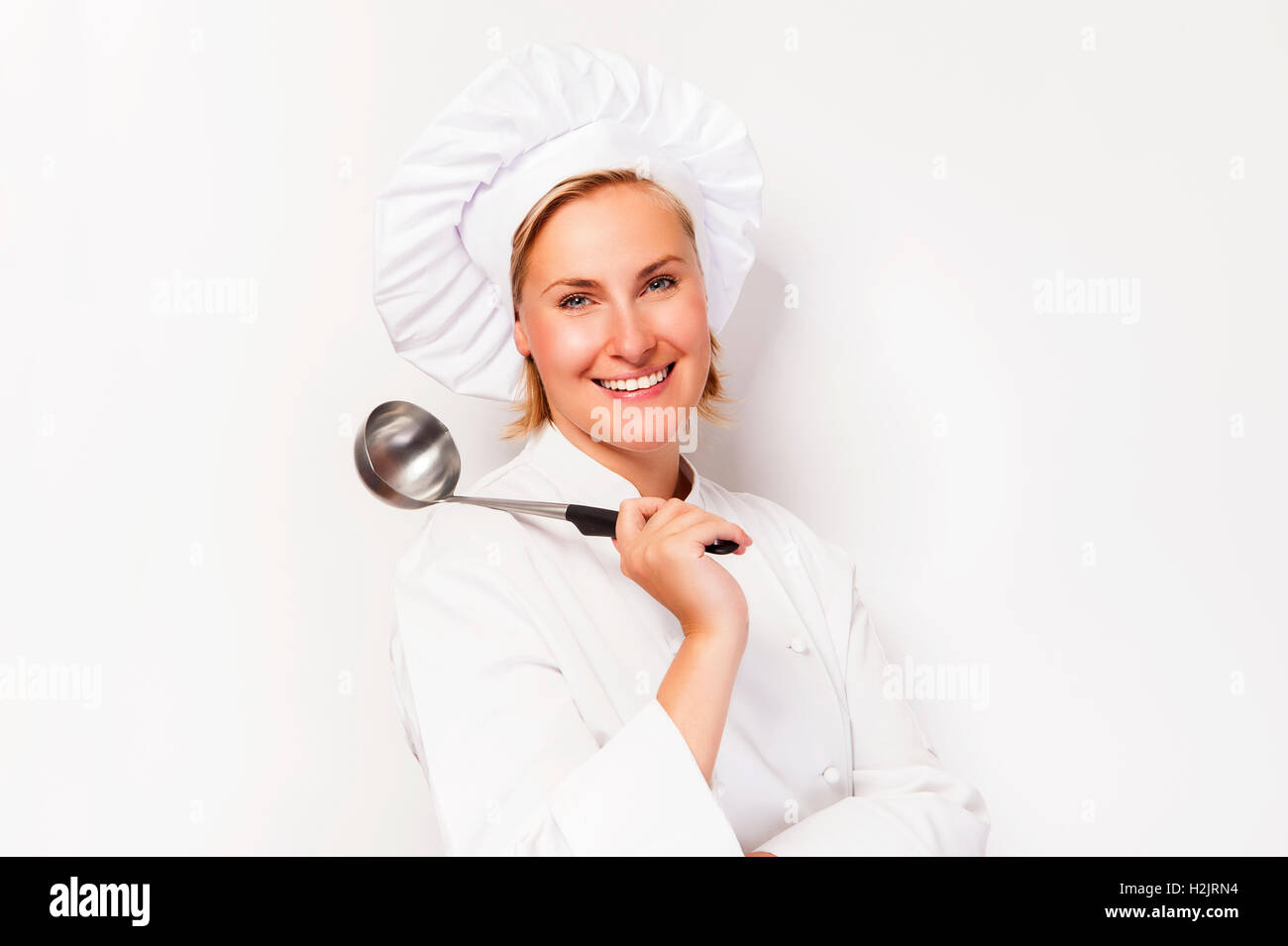 Young woman chef holding ladle, smiling Stock Photo - Alamy