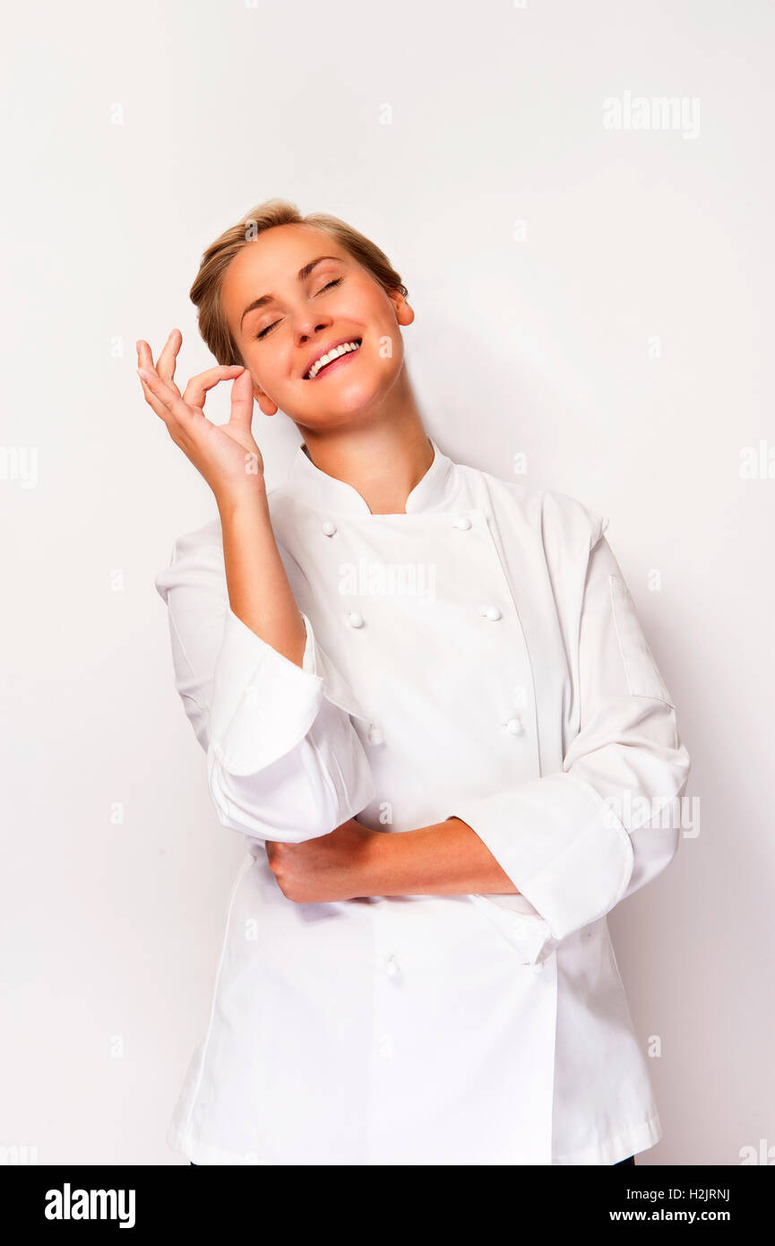 Woman chef showing sign perfect hand, over whita background smiling ...