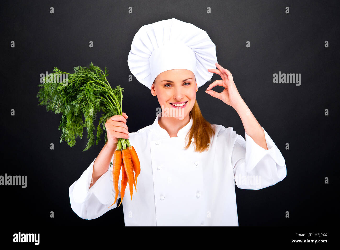 female cook in white uniform with bunch of carrots Stock Photo - Alamy