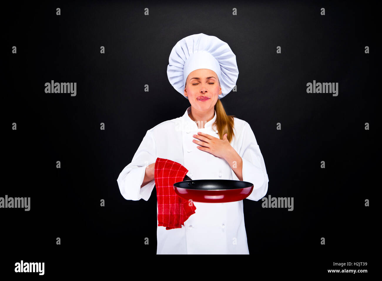 cooking and food concept - smiling female chef over dark background ...