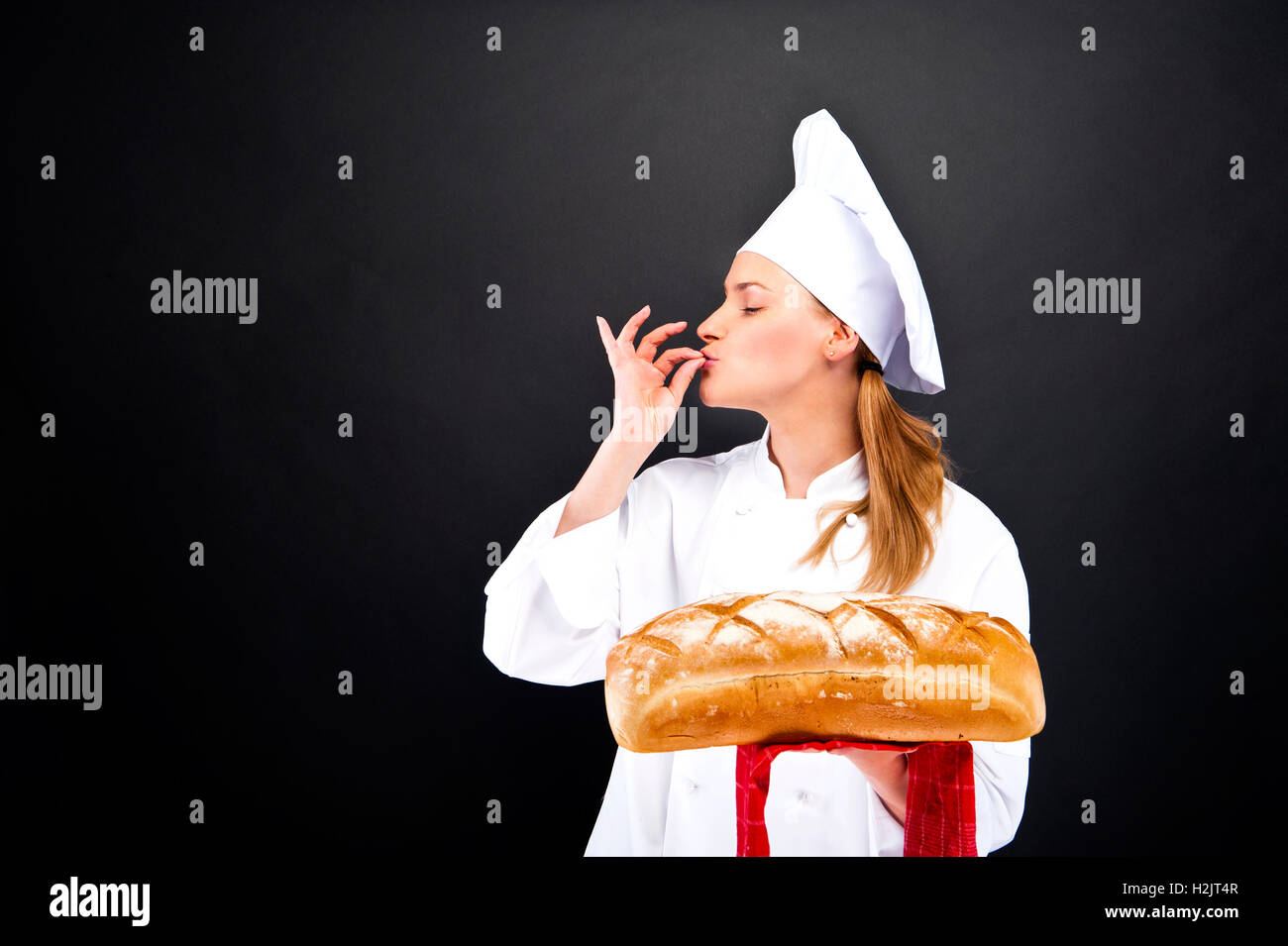 Chef baker smelling fresh baked bread Stock Photo - Alamy