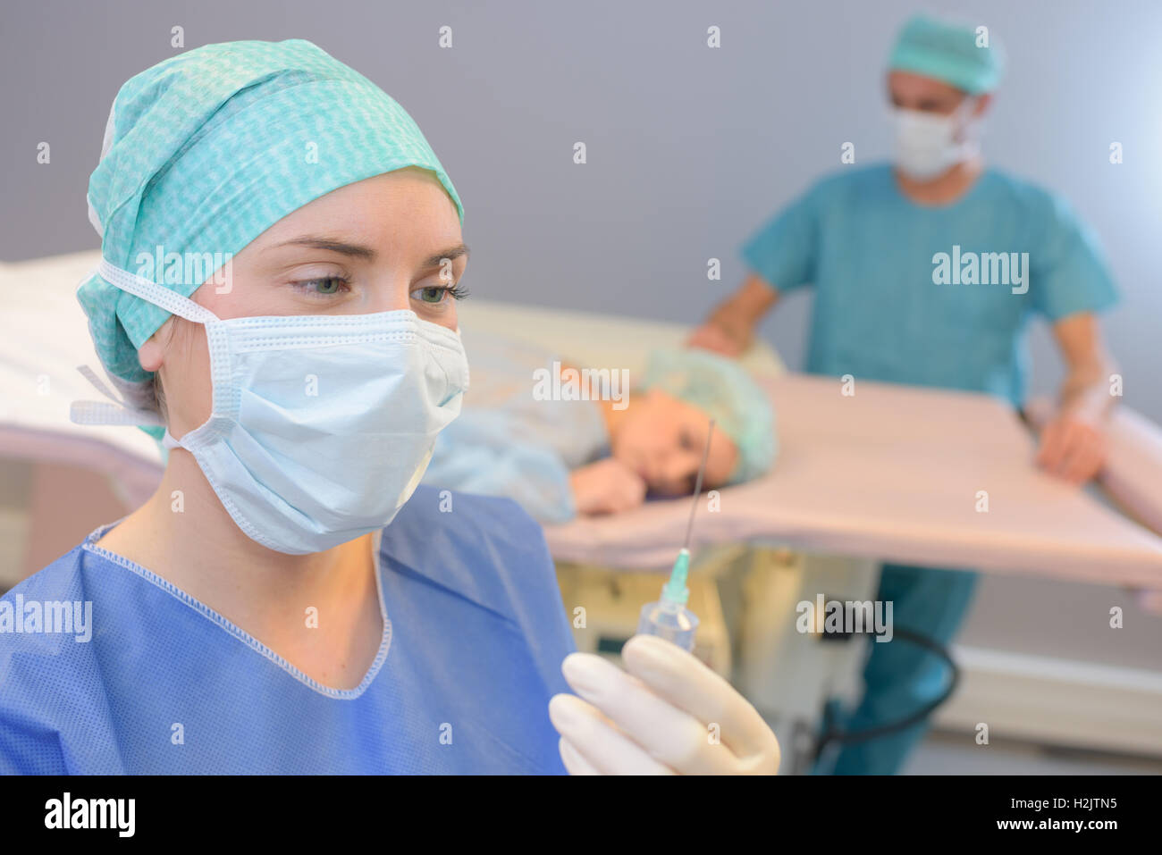 Masked nurse preparing injection Stock Photo - Alamy