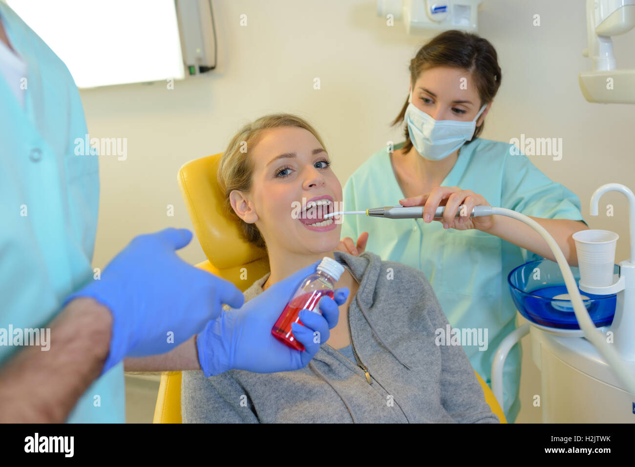 dentist curing a woman patient in the dental office Stock Photo - Alamy