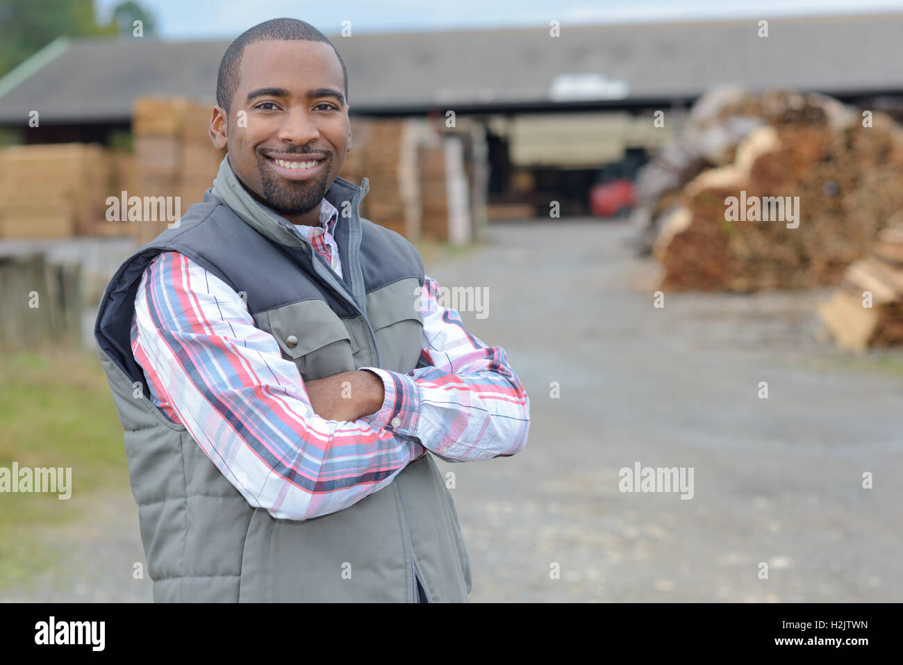Portrait of man in wood yard Stock Photo - Alamy