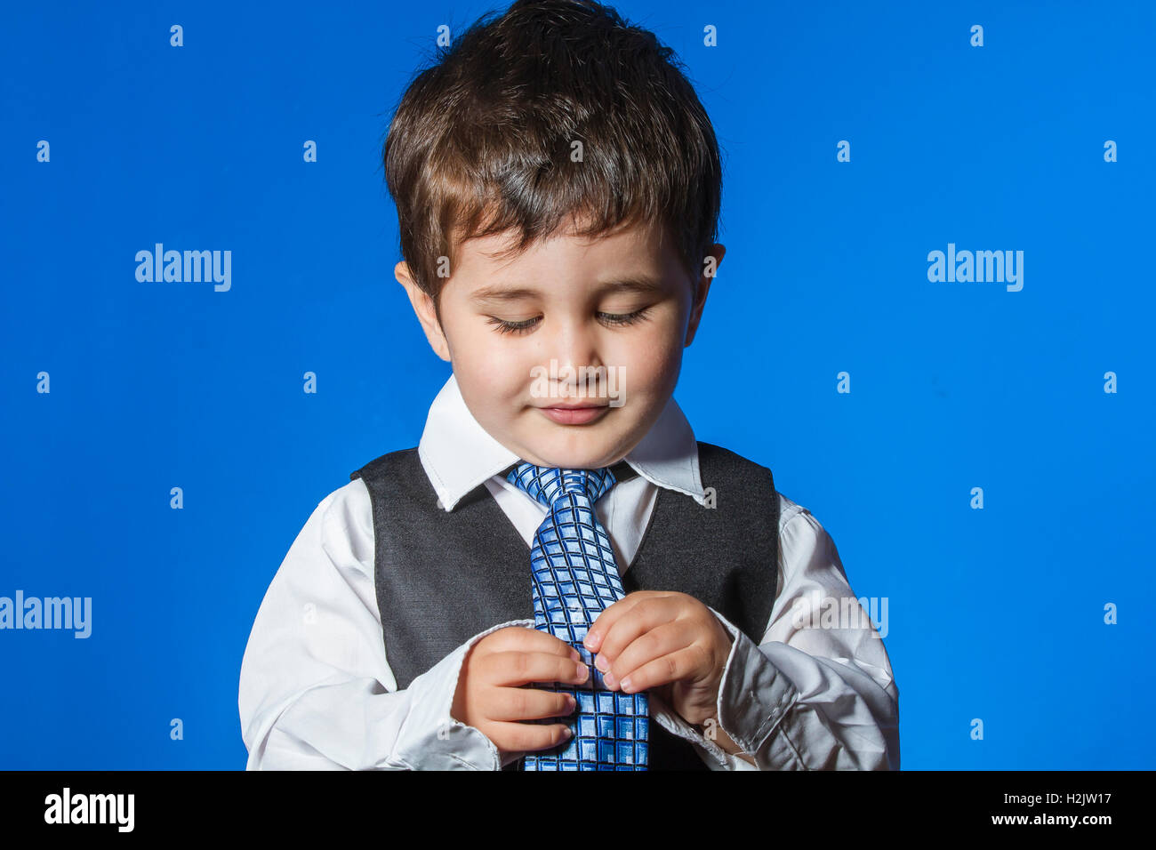 Leader, cute little boy portrait over blue chroma background Stock ...