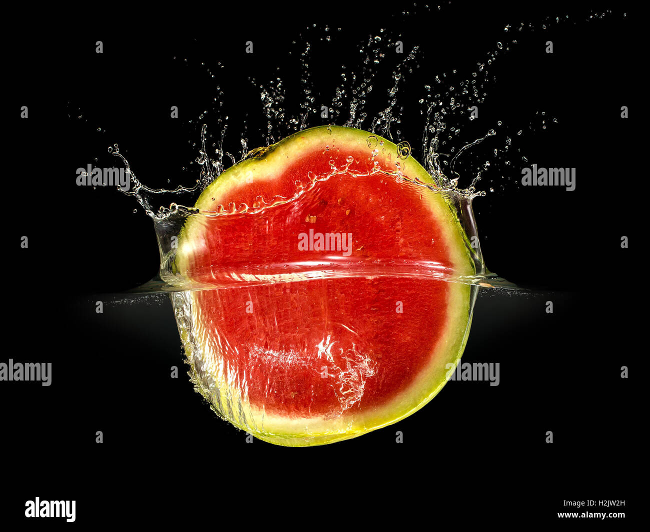Fresh melon falling in water with splash on black background Stock ...
