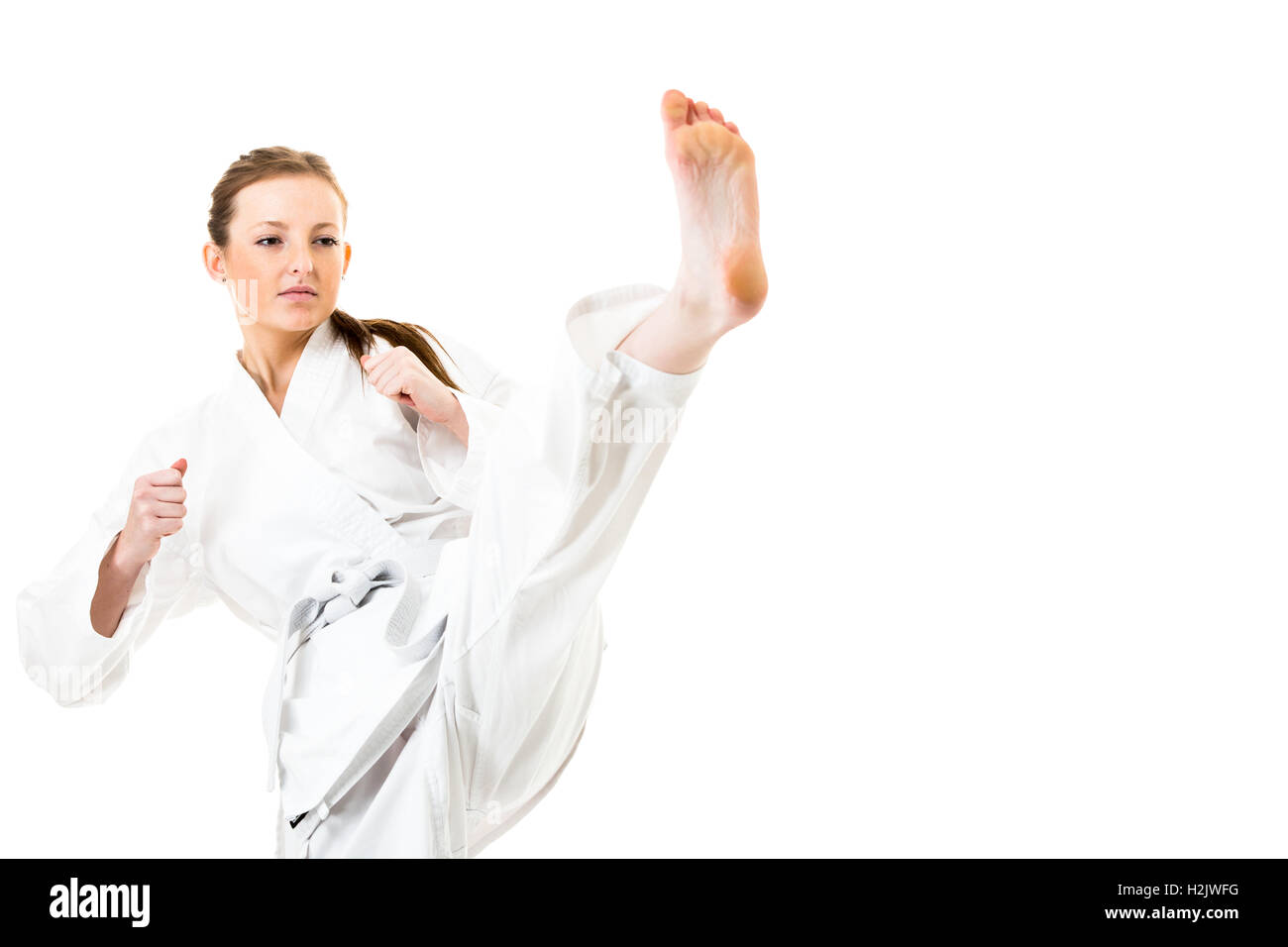 Beautiful caucasian, young, woman makes a kick Stock Photo - Alamy