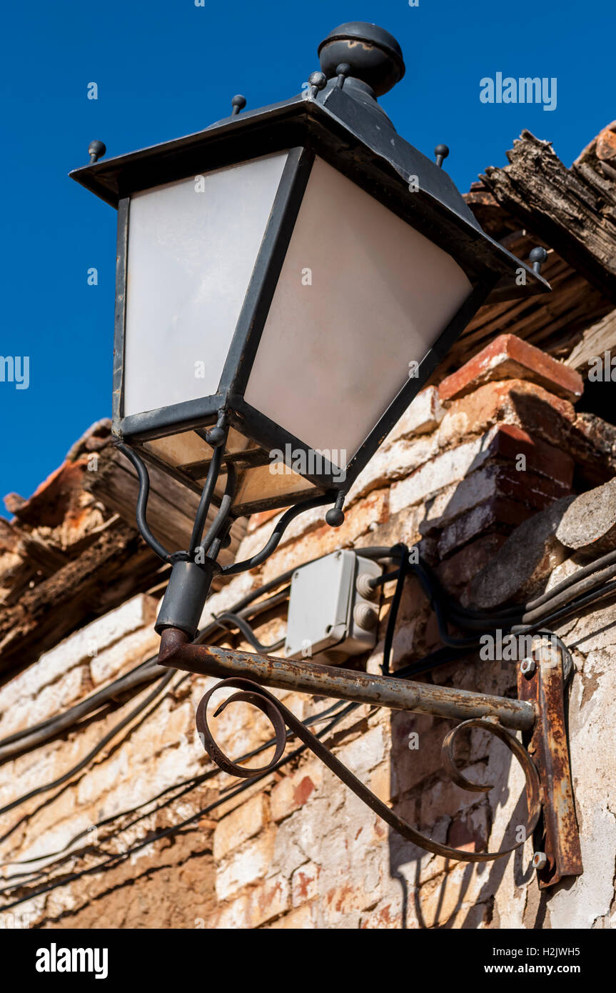 Street light on stone wall, spain Stock Photo - Alamy