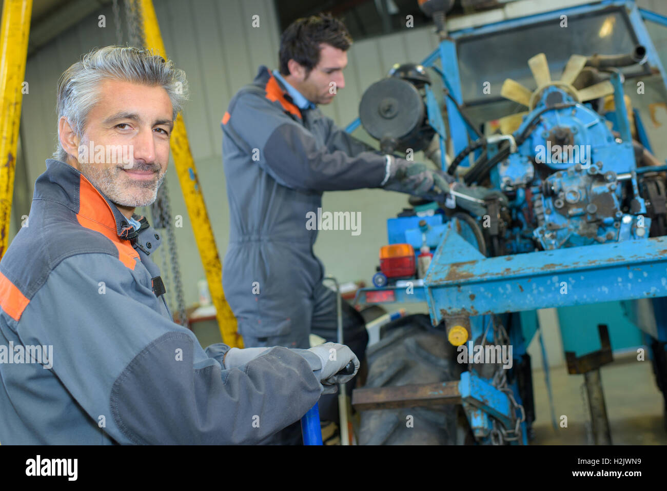 fixing a tractor Stock Photo - Alamy