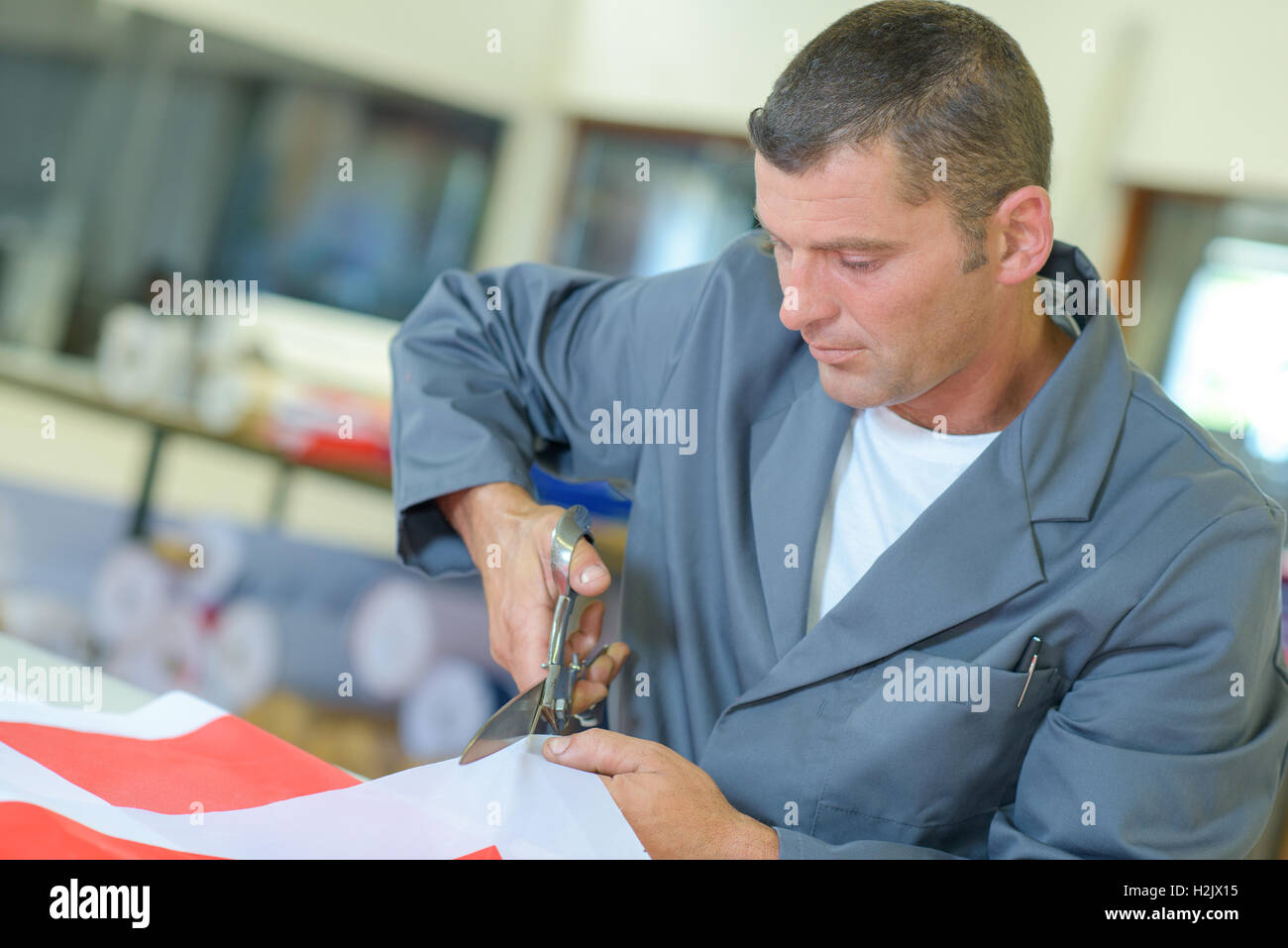 Man cutting material Stock Photo - Alamy