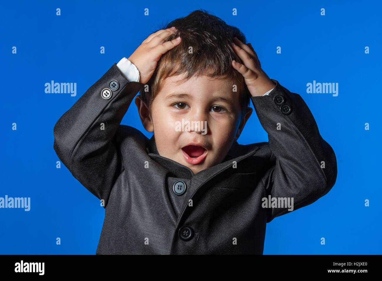 Leader, cute little boy portrait over blue chroma background Stock ...