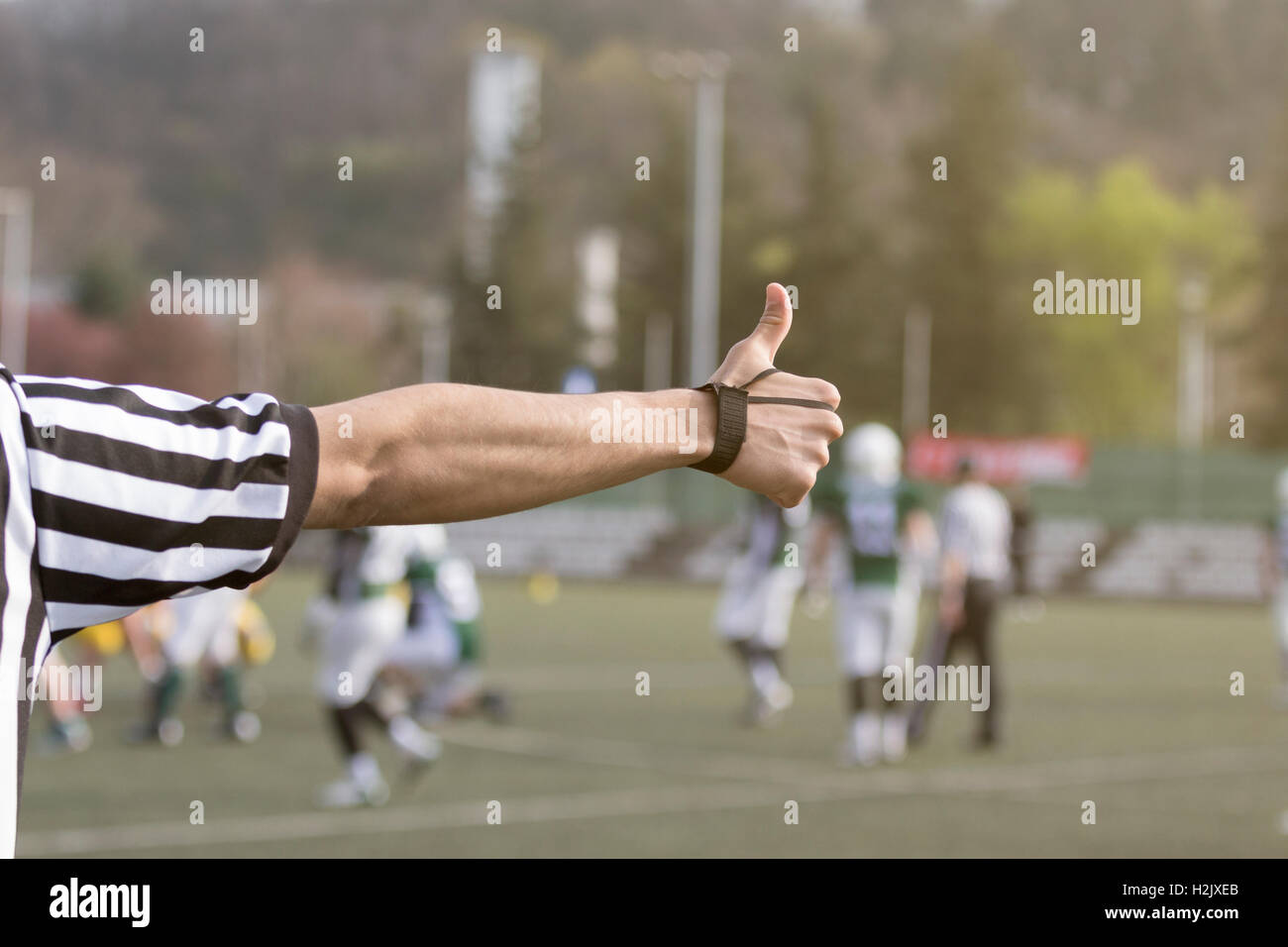 Hand of football referee showing signal with his thumb up Stock Photo ...