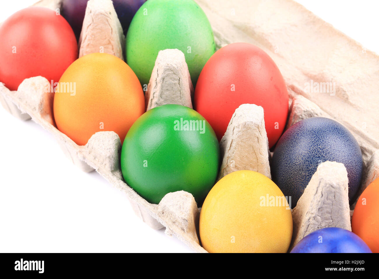 Cardboard egg box with Easter colored eggs Stock Photo - Alamy