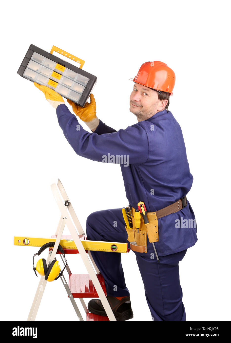 Worker on ladder with hammer Stock Photo - Alamy