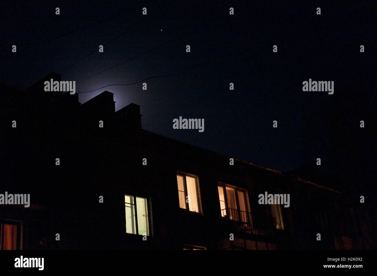 Moon glow over a rooftop of a house at night Stock Photo - Alamy