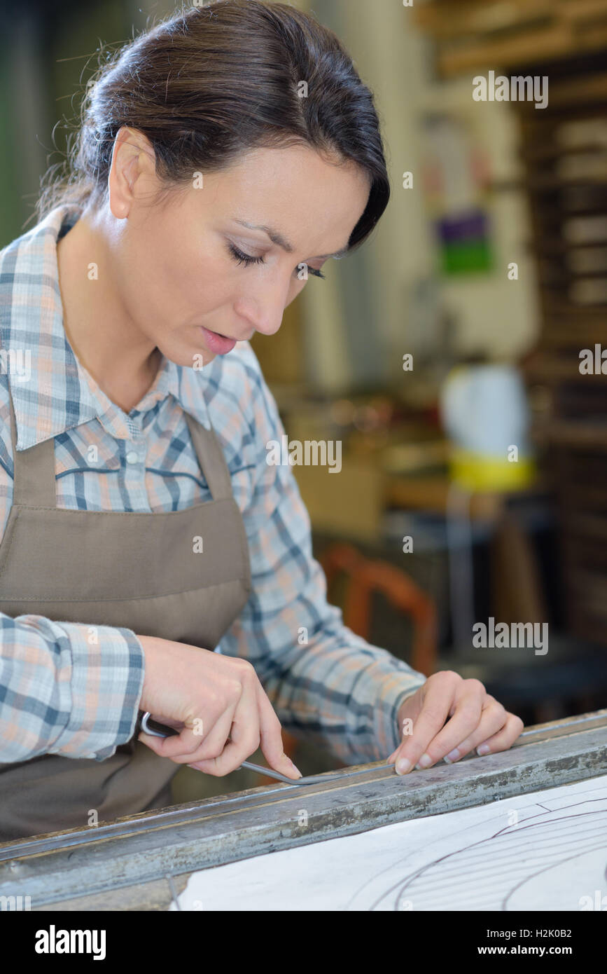 Female artist pressing into mold Stock Photo - Alamy