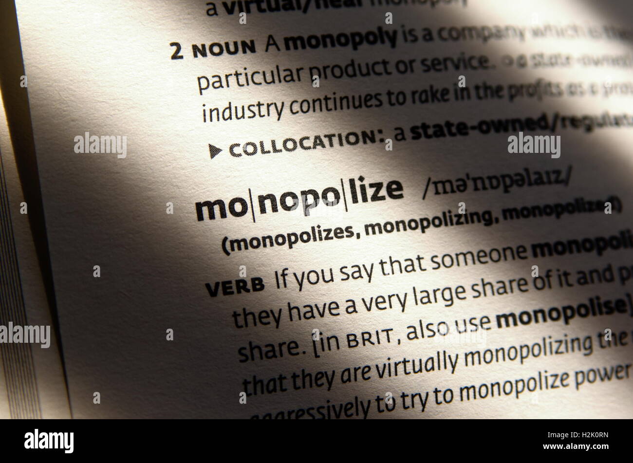 monopolize word in the open book Stock Photo - Alamy