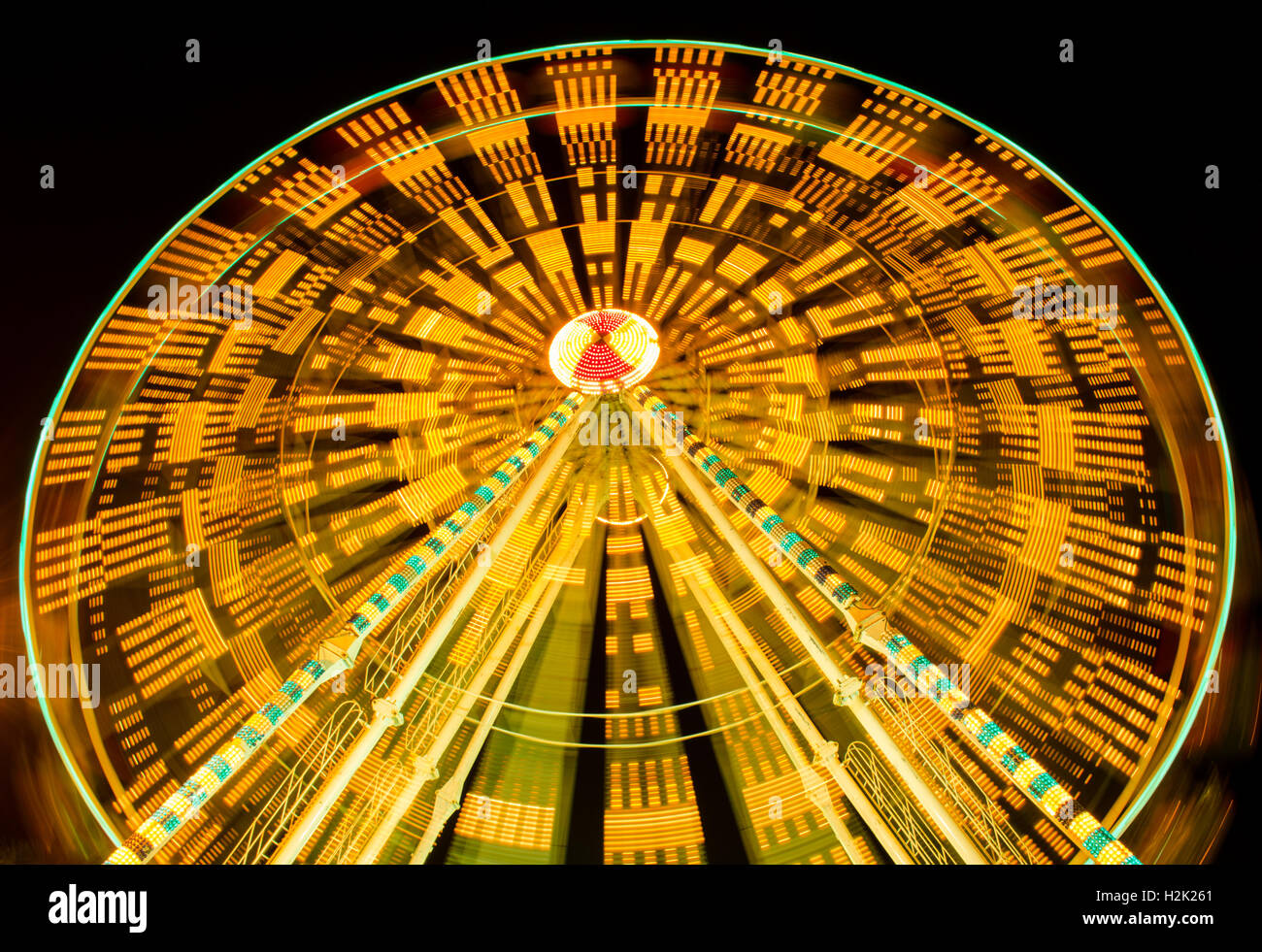 ferris wheel spinning at fairground at night Stock Photo - Alamy