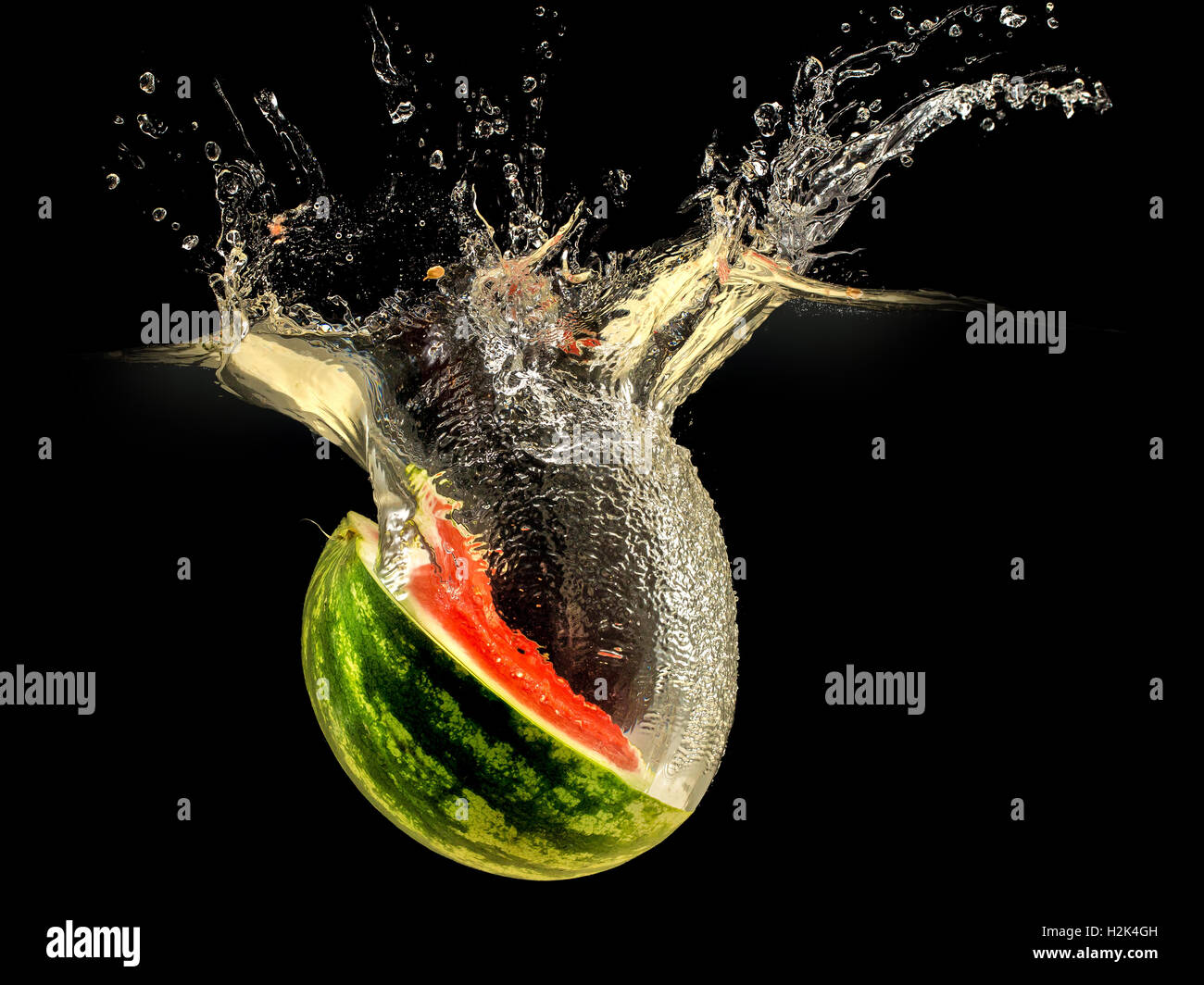 Fresh melon falling in water with splash on black background Stock ...