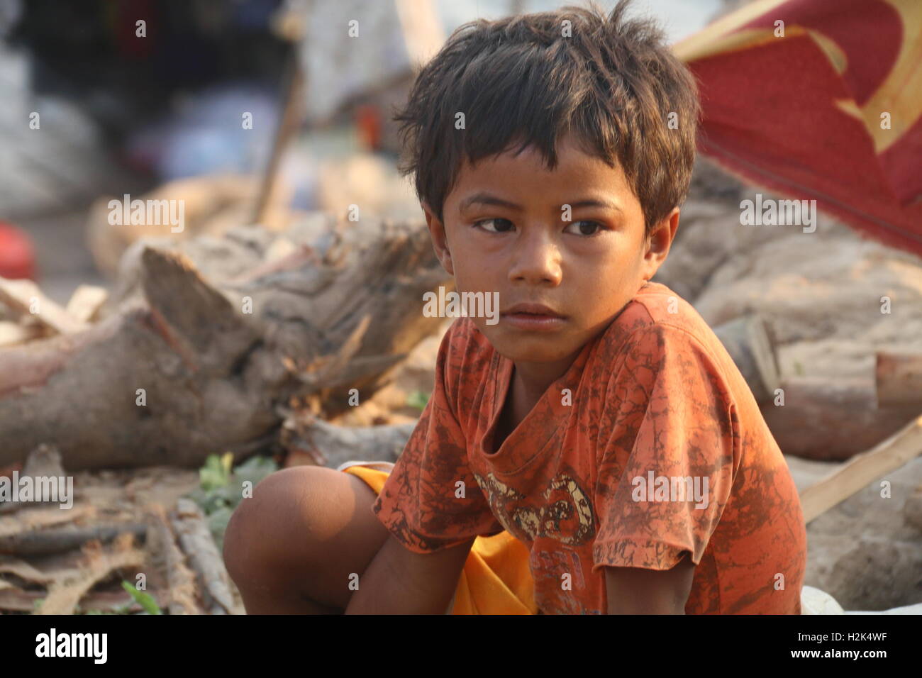 A child sits in a pile of rubbish Stock Photo - Alamy