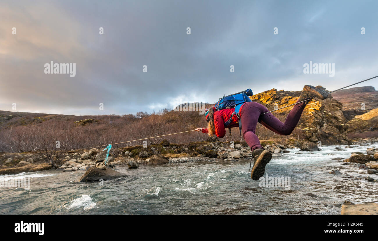 Young woman crossing river rope hi-res stock photography and images - Alamy