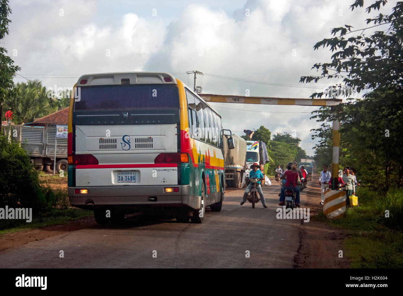 A tall bus ties up traffic as it measures the vertical clearance of a ...