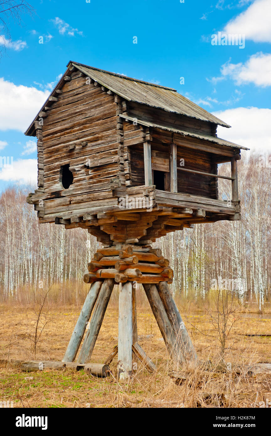 wooden house on poles in the field Stock Photo - Alamy