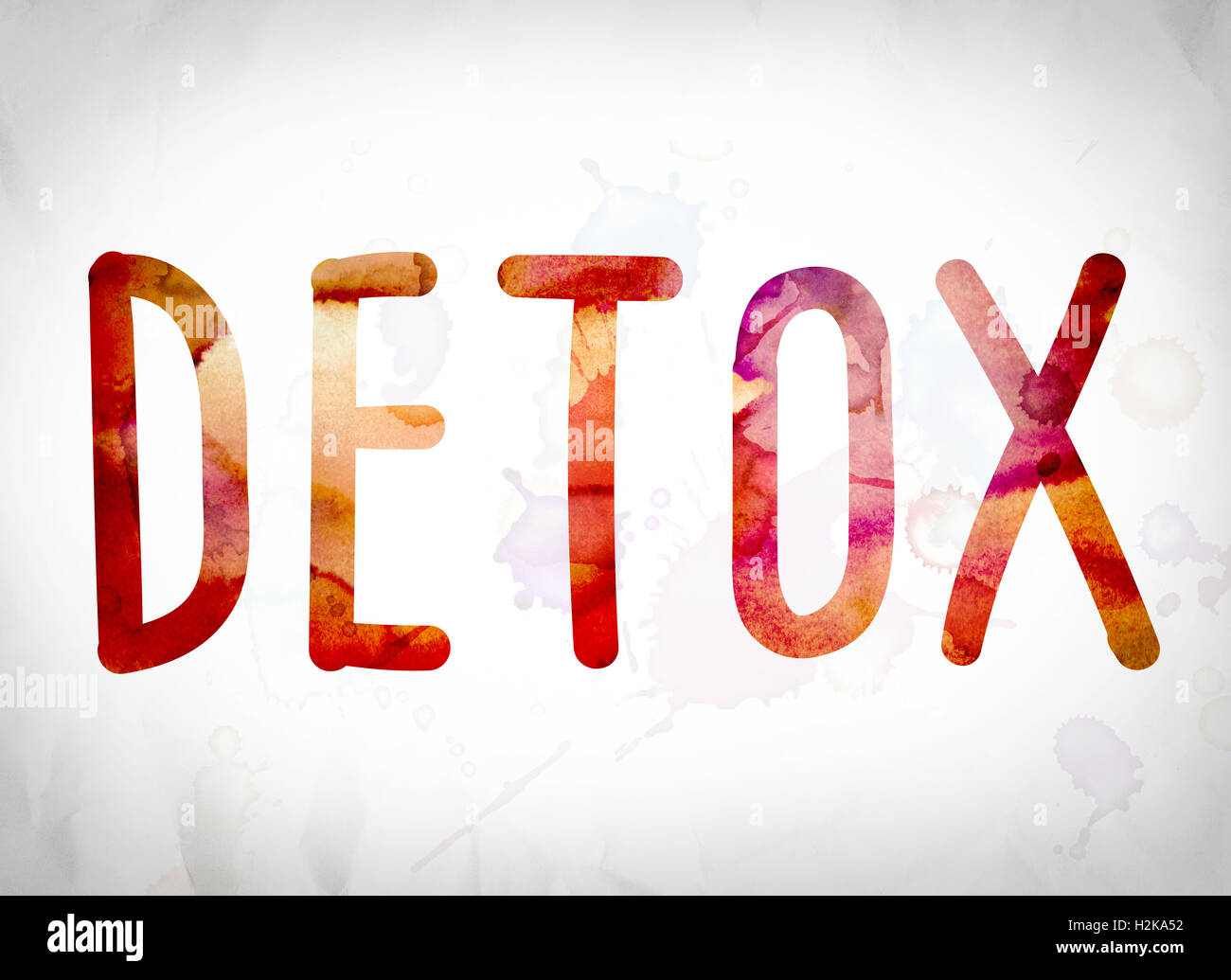 The word "Detox" written in watercolor washes over a white paper ...