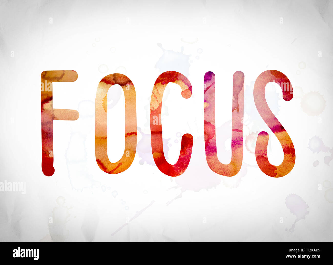 The word "Focus" written in watercolor washes over a white paper ...