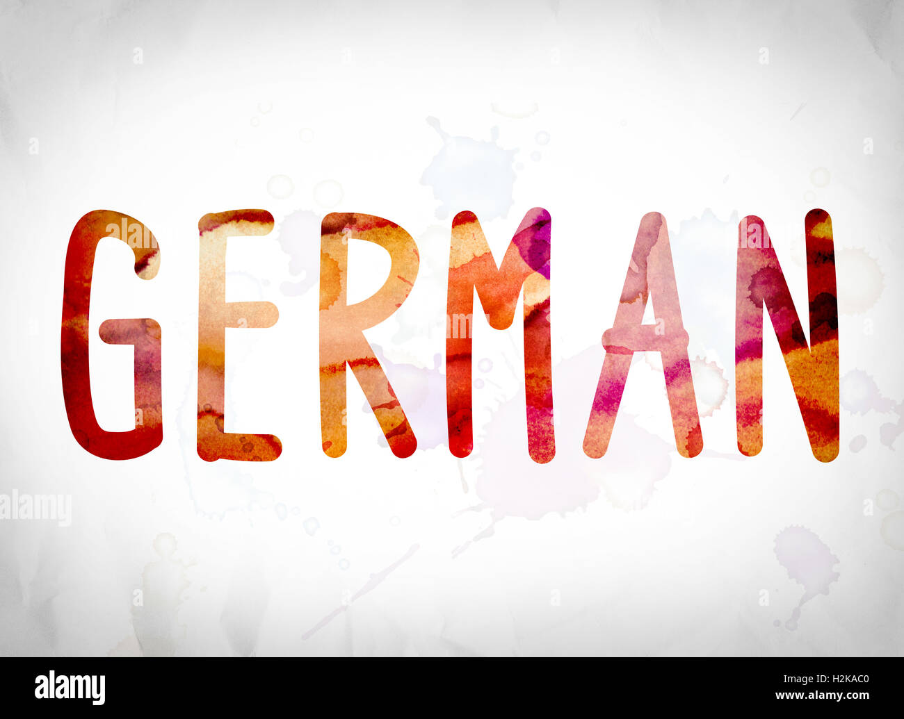 The word "German" written in watercolor washes over a white paper ...