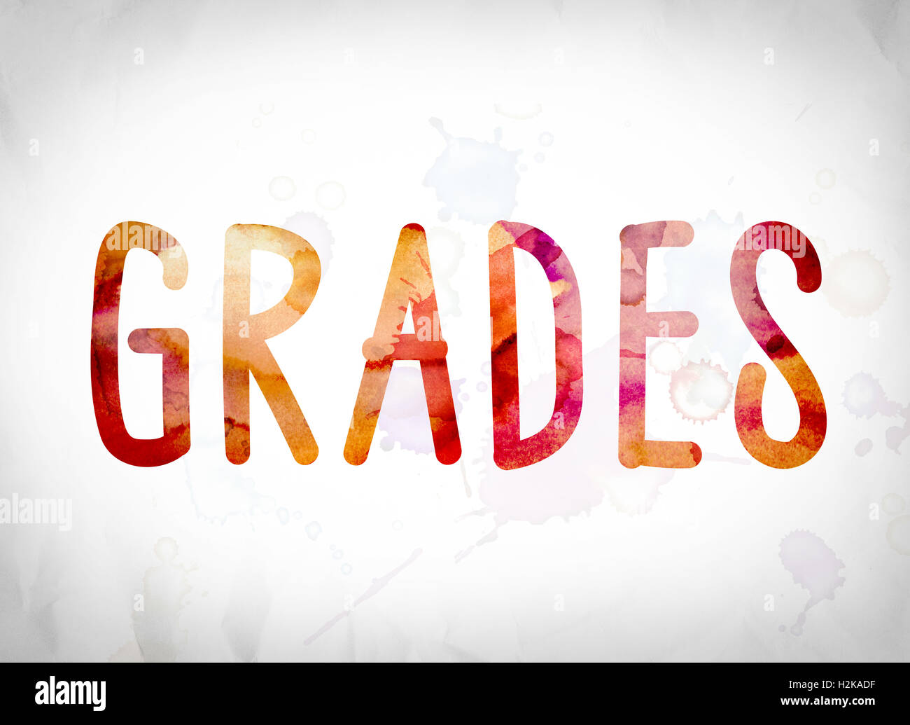 The word "Grades" written in watercolor washes over a white paper ...