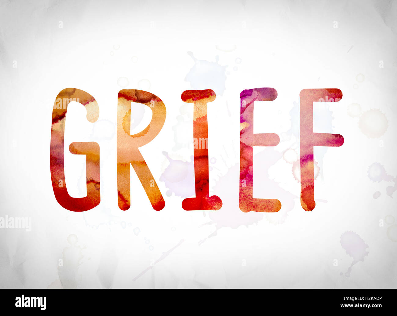 The word "Grief" written in watercolor washes over a white paper ...