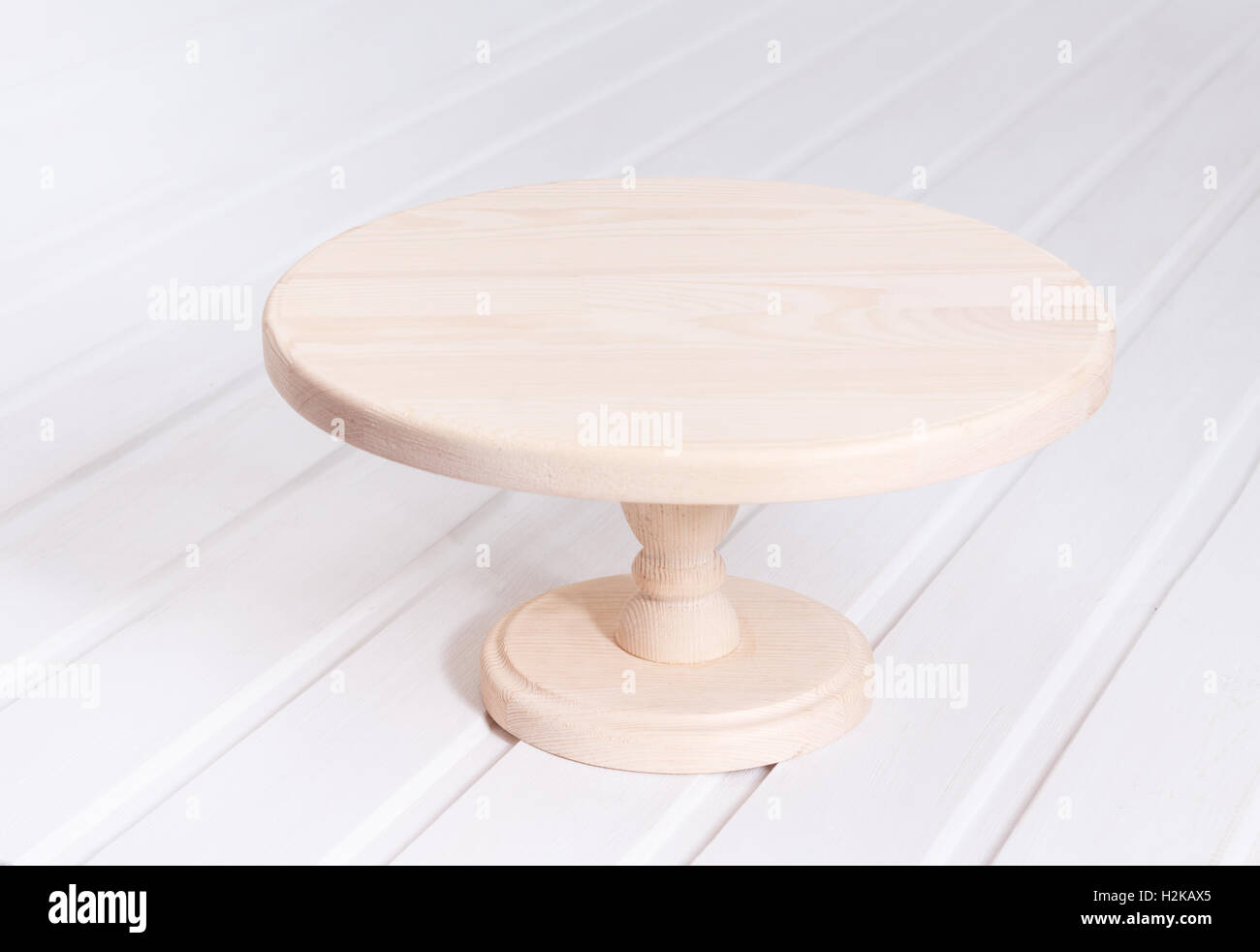 Empty wooden stand for cake Stock Photo - Alamy