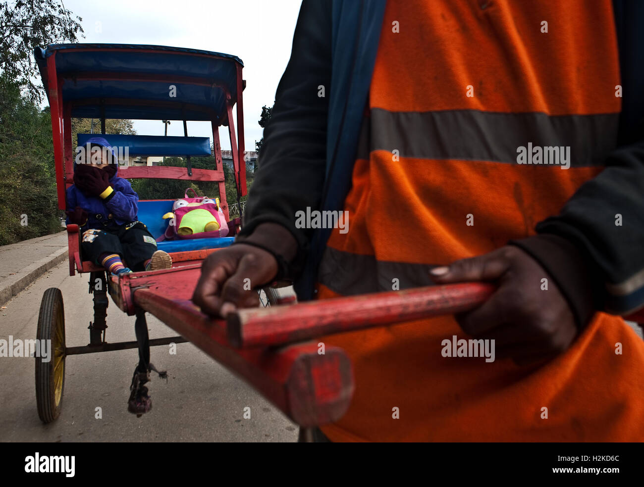 Pulled rickshaw carrying a boy going to school ( Madagascar Stock Photo ...