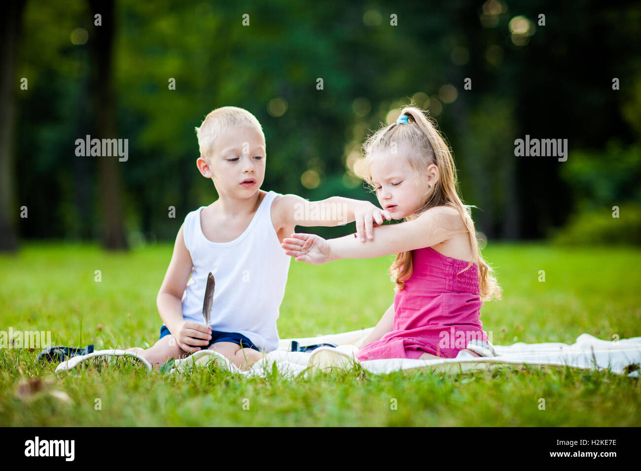 Little boy and girl with ladybird in park during beautiful summer ...