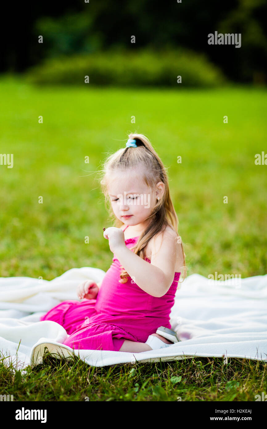 Little girl in a park during beautiful summer evening Stock Photo - Alamy