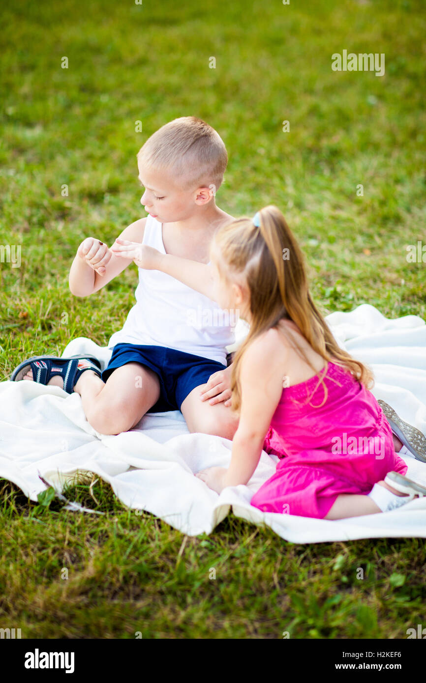 Little boy and girl with ladybird in park during beautiful summer evening Stock Photo - Alamy