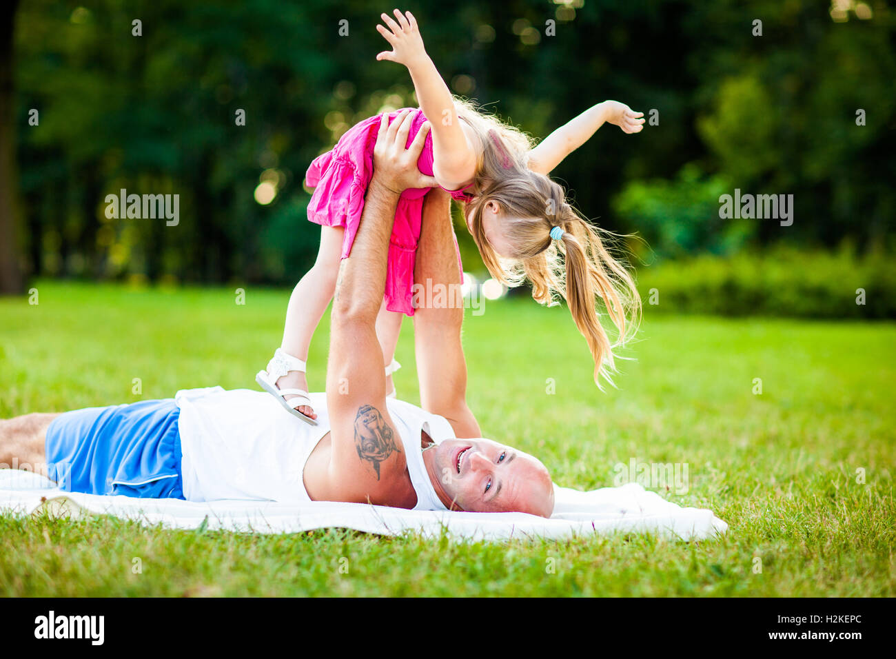 Family having fun in a park during beautiful summer evening Stock Photo ...