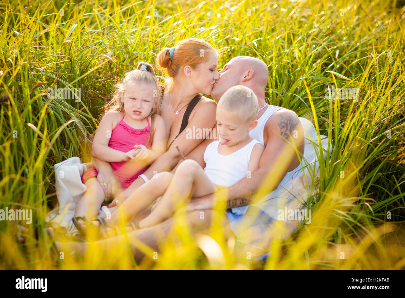 Family having fun in a park during beautiful summer evening Stock Photo ...